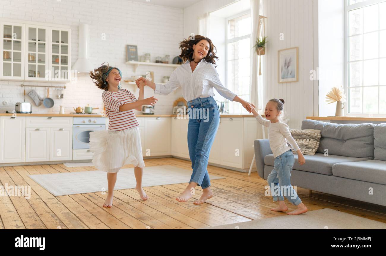 Mom and her daughters children girls are dancing. Family holiday and ...