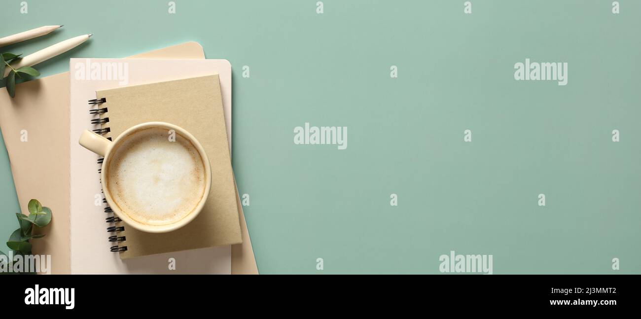 Banner with cup of coffee, stack of paper notebooks and eucalyptus ...
