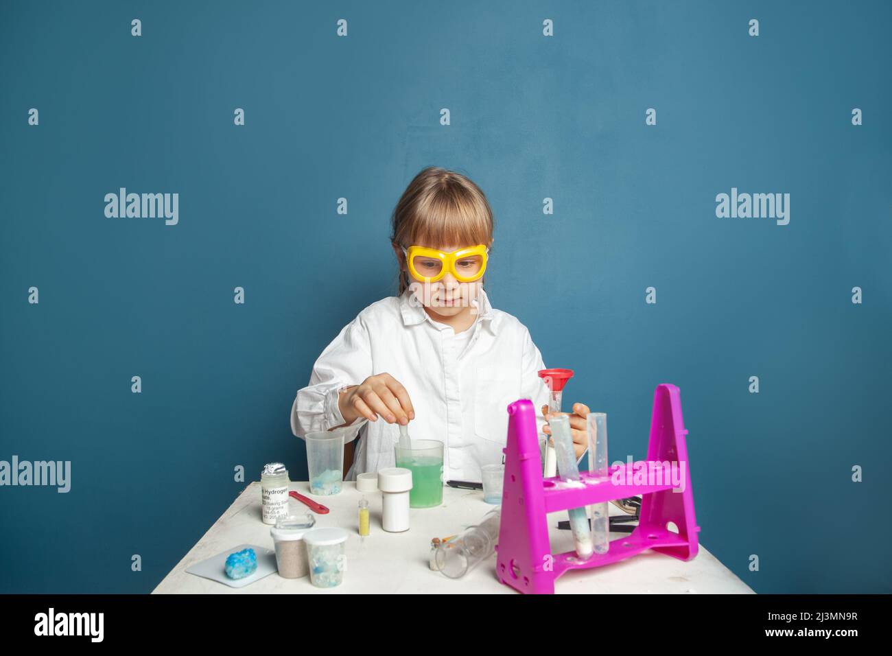 Clever child student wearing uniform and glasses with science ...