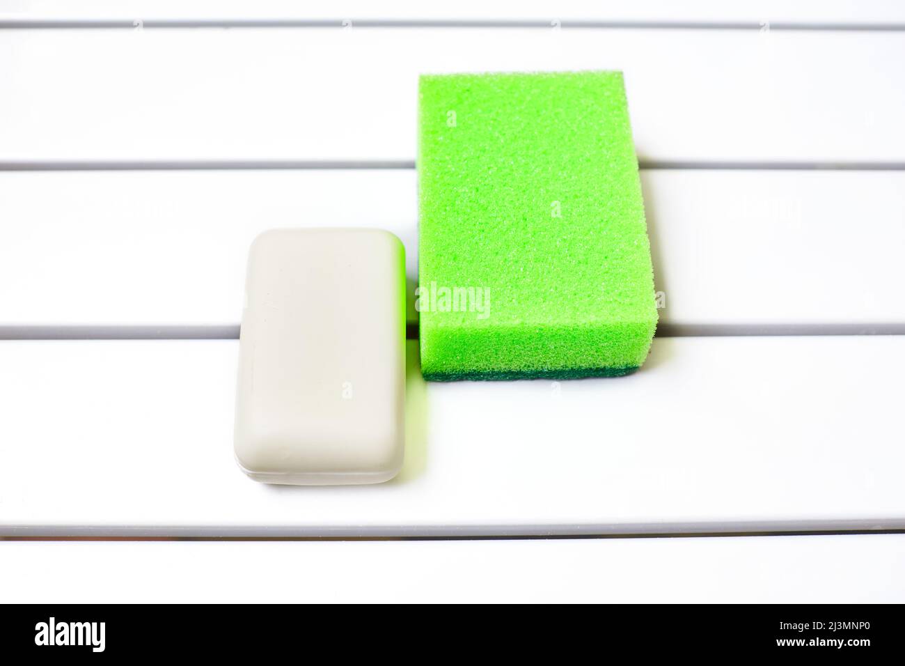 Green sponge and white soap for cleaning Stock Photo - Alamy