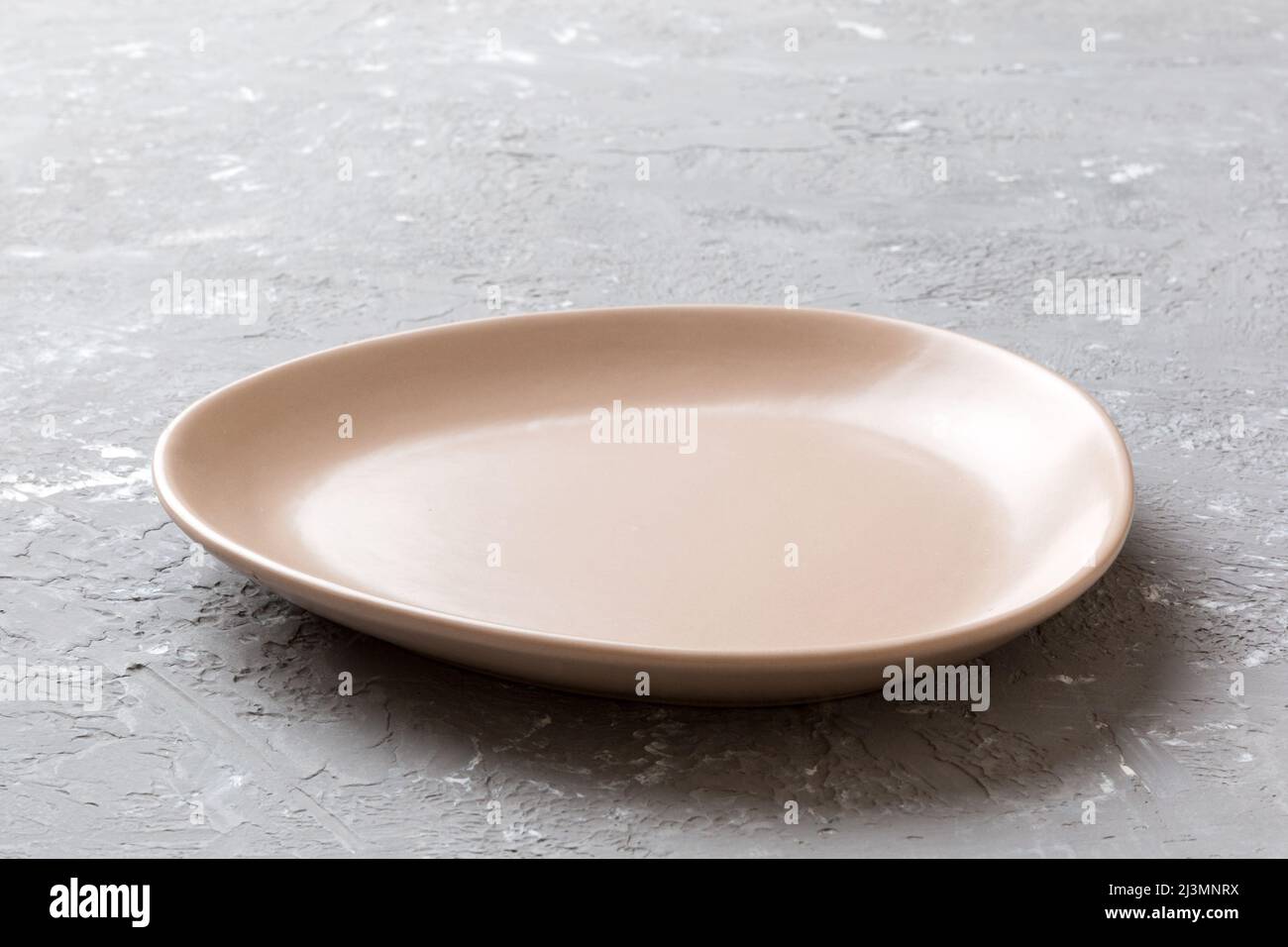 Perspective view of empty pink plate on cement background. Empty space ...