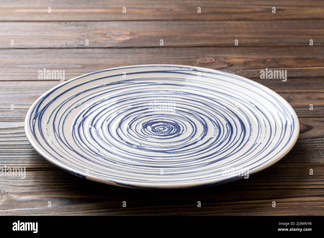 Perspective view of empty colorful plate on cement background. Empty ...
