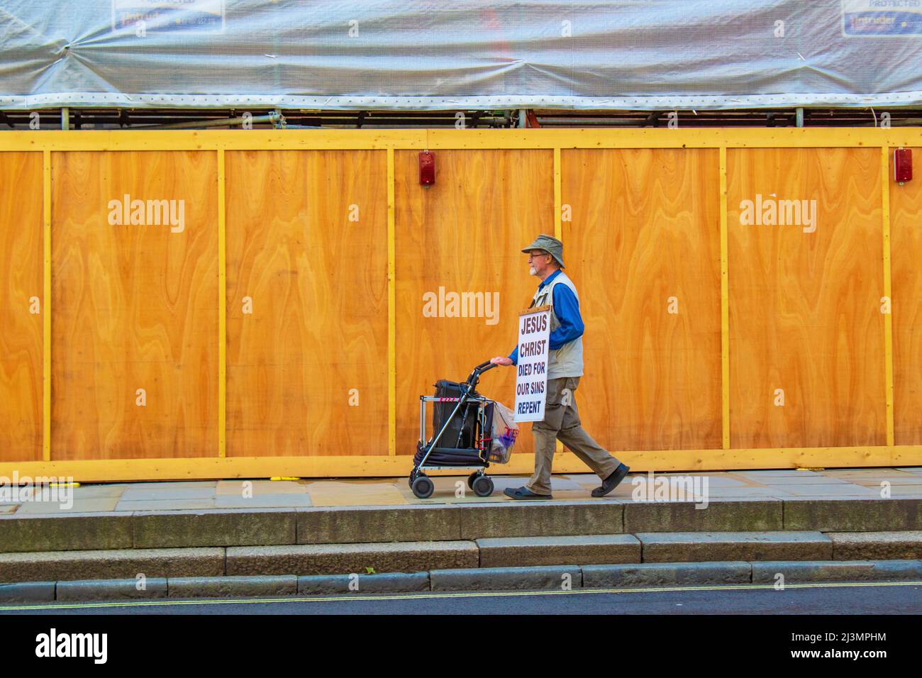Man with a placard with the inscription: ``Jesus Christ died for our ...