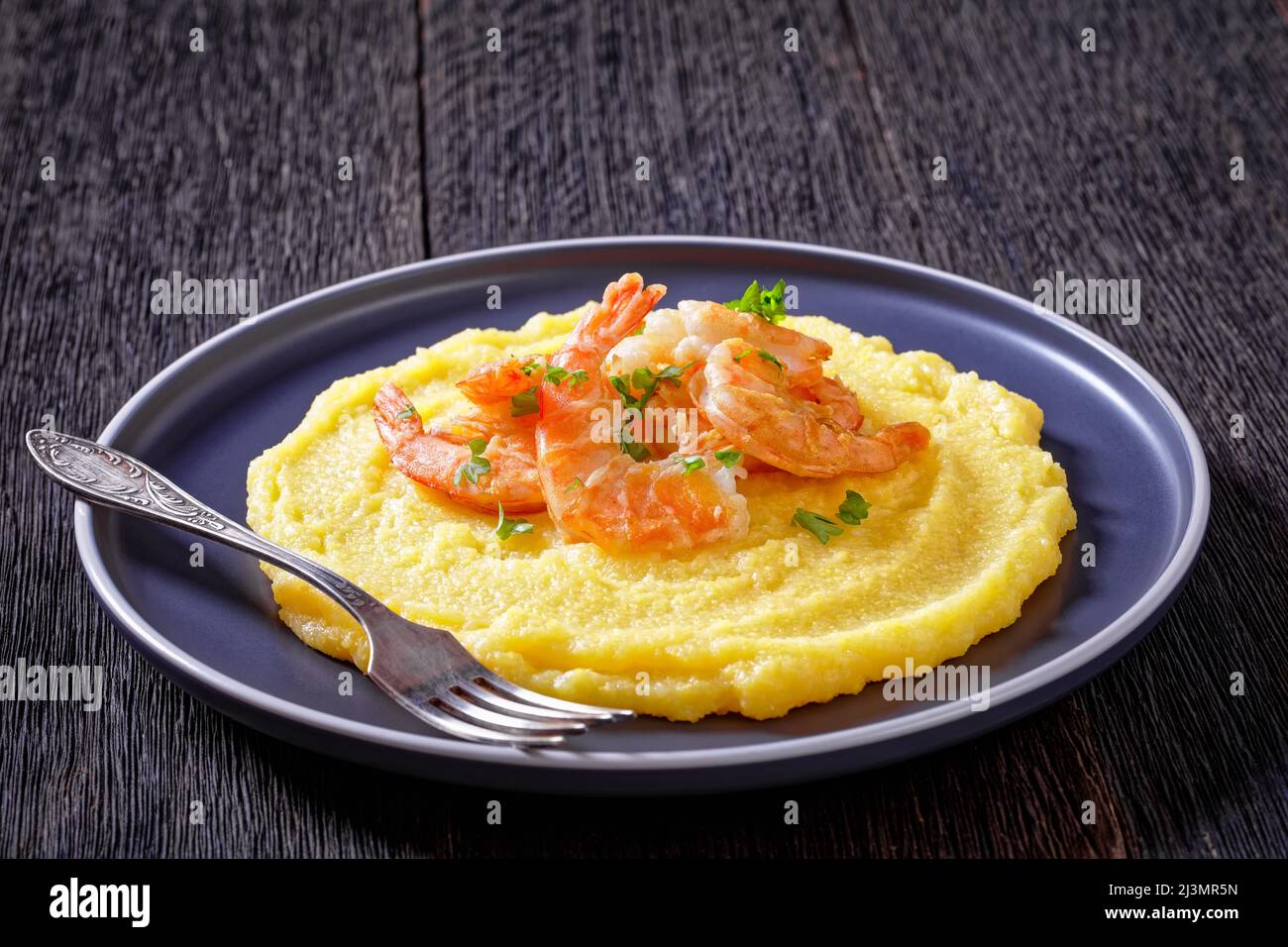 Schie with polenta, venetian dish, polenta with fried shrimps on a ...