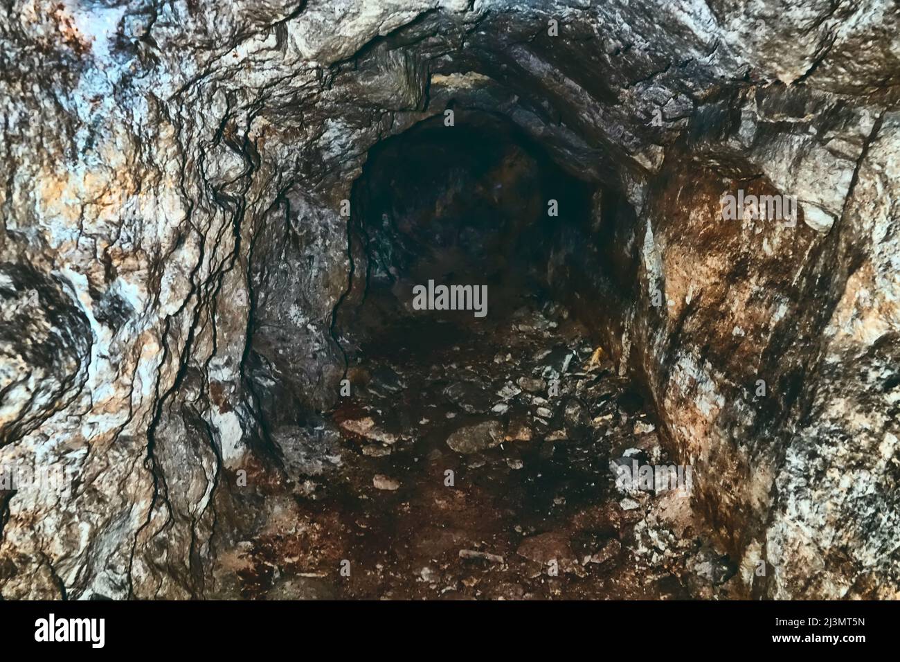 An old mine, an underground corridor, and walls covered with mineral ...