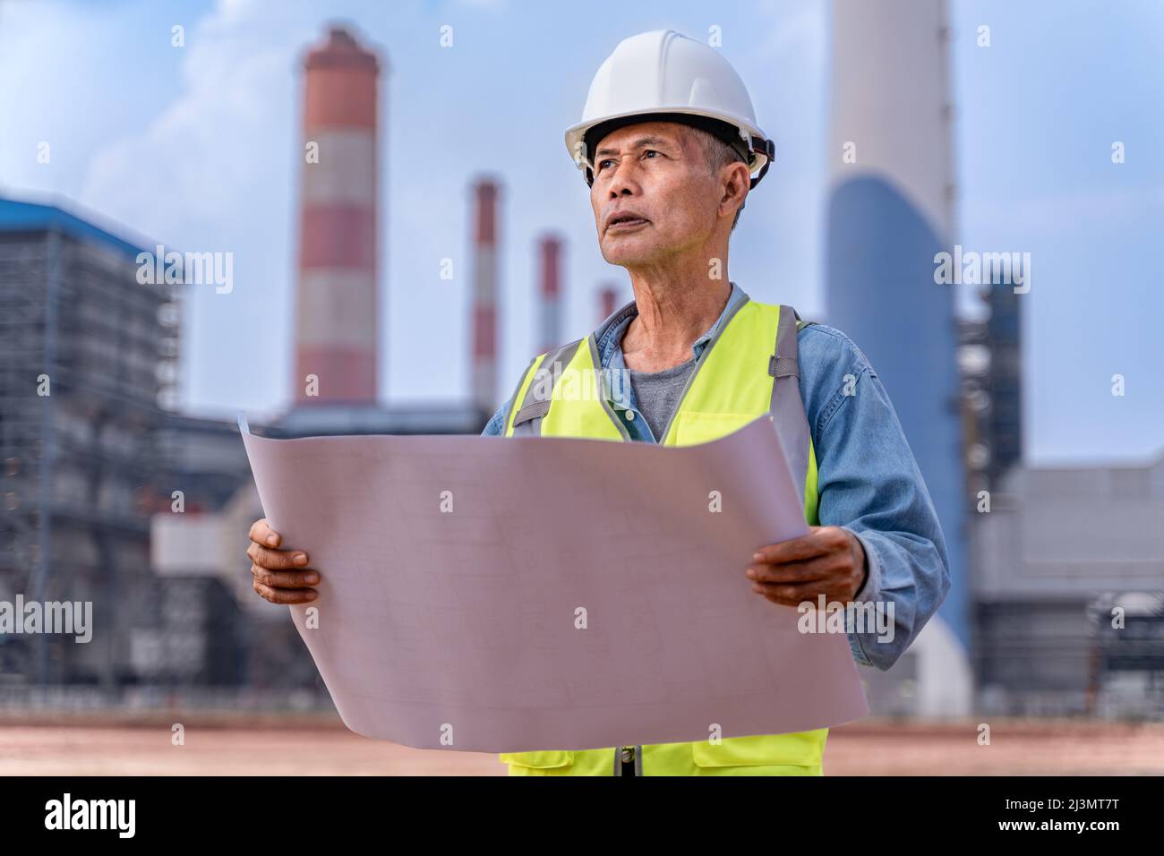 Senior supervisor engineer in his work cloths holding construction ...