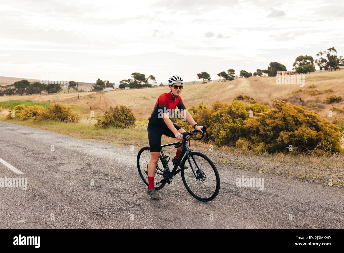Full length of a pro cyclist taking a break from intense training on ...