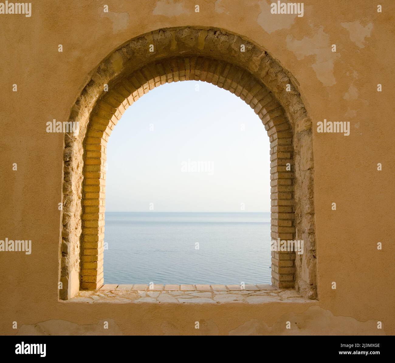 arched window of bricks on the sea Stock Photo - Alamy
