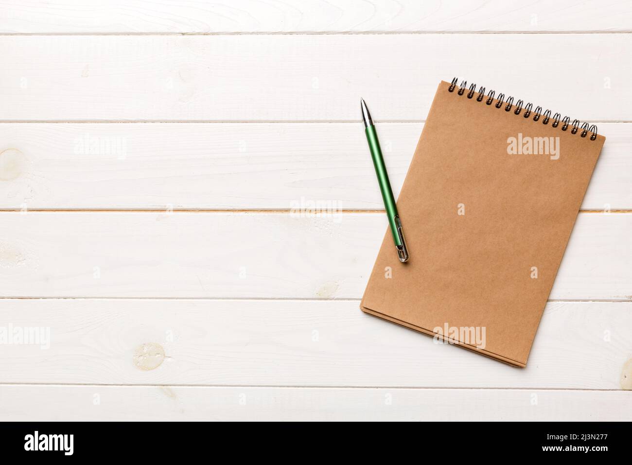 school brown notebook on a colored background, spiral craft notepad on ...