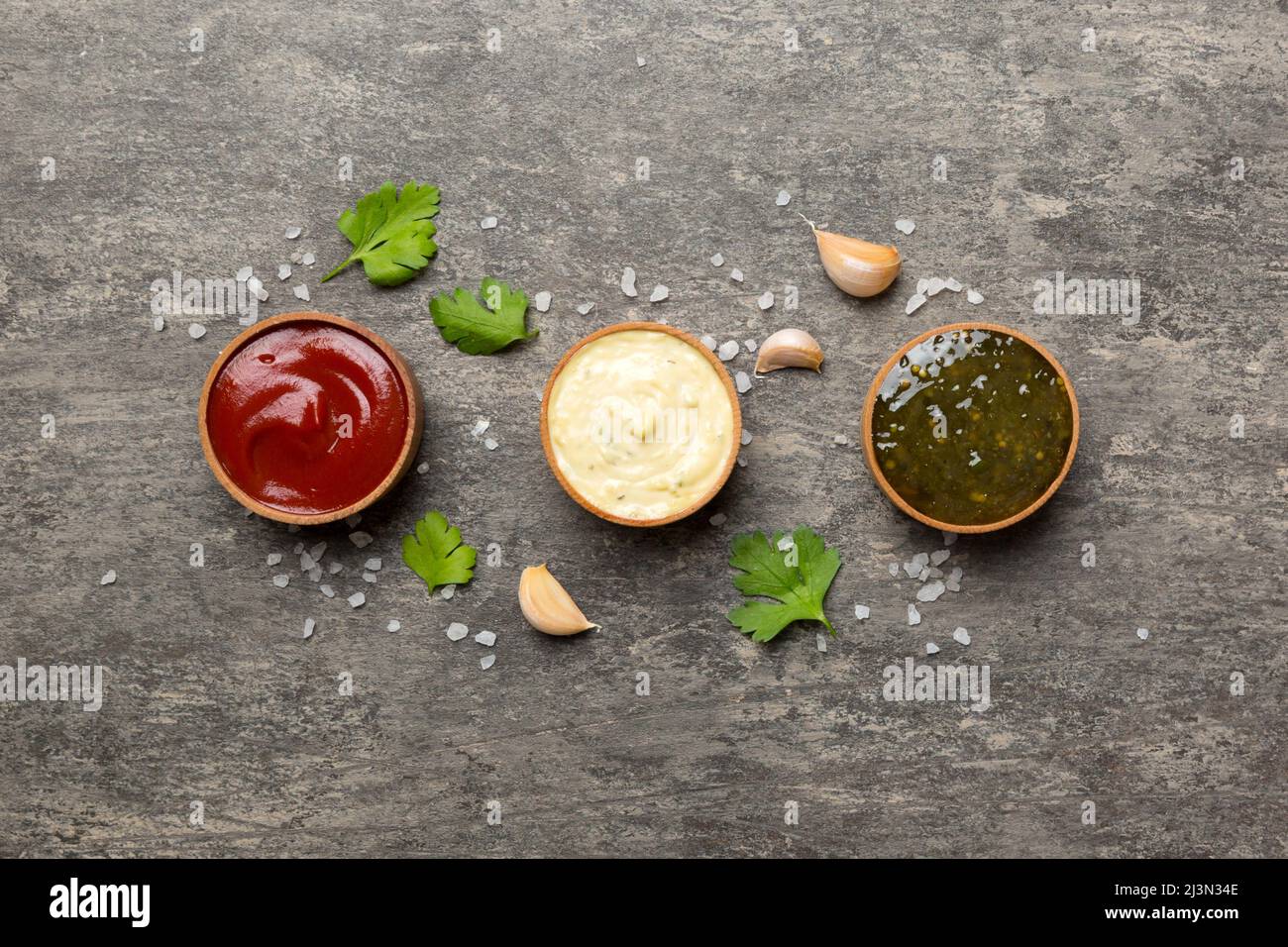 Many different sauces and herbs on table, flat lay top view. sauces ...