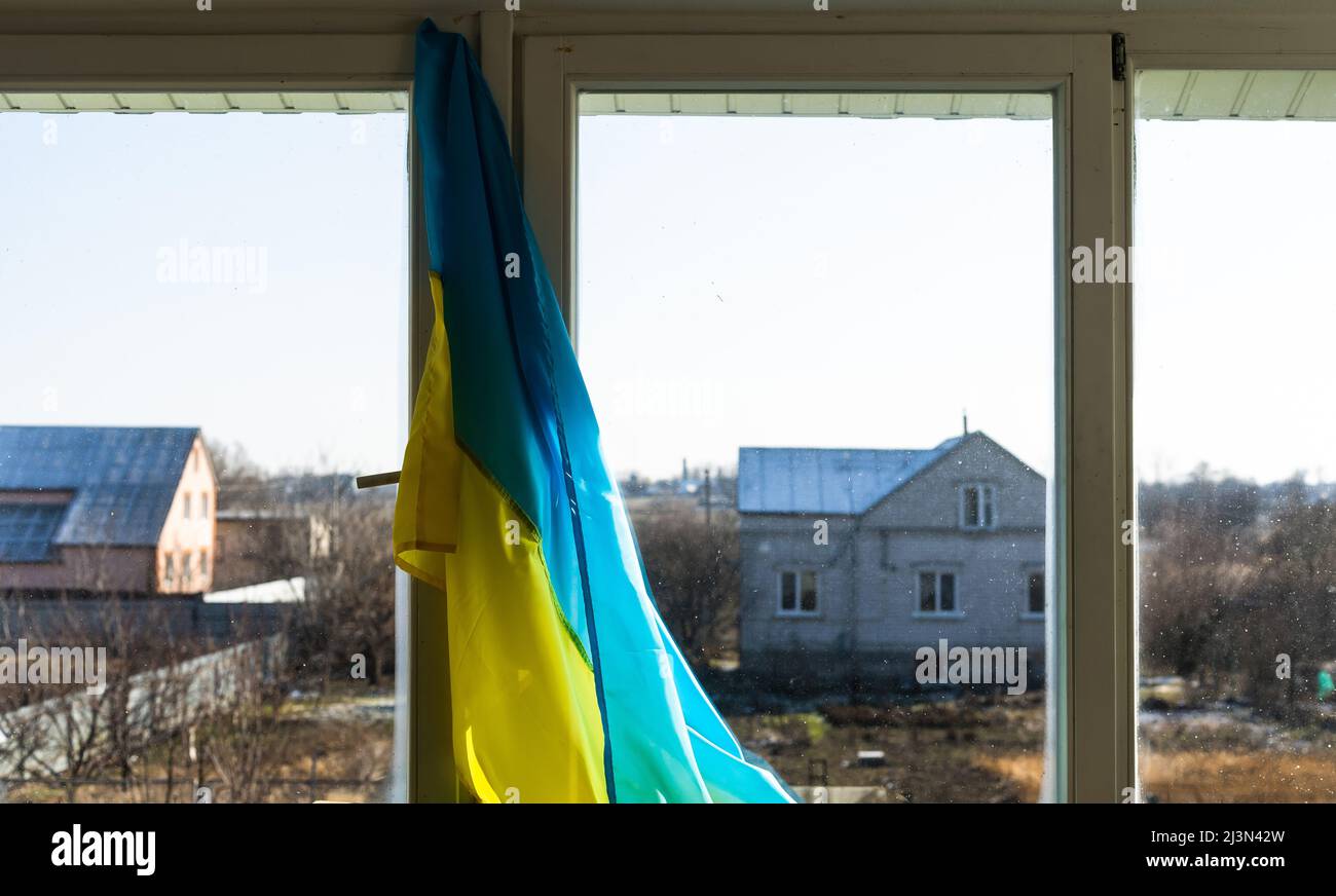 Flag of Ukraine on the window sealed with tape. No war. War in Ukraine ...