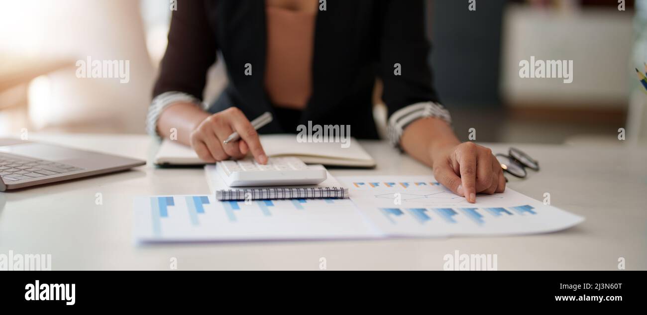 Accountant calculate financial report, computer with graph chart ...