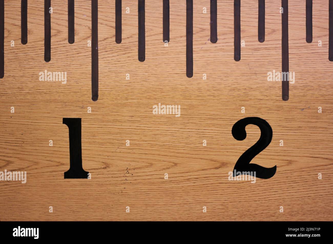 Closeup of the numbers one and two of a traditional wooden school ruler ...