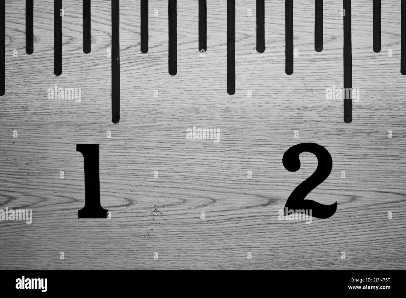 Closeup of the numbers one and two of a traditional wooden school ruler ...