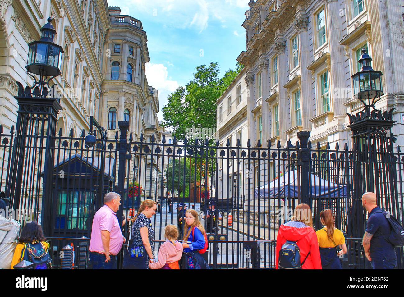 Tourists and protesting man outside the gates of 10 Downing Street in ...