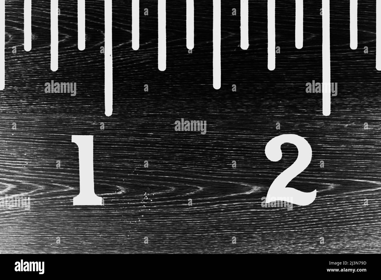 Closeup of the numbers one and two of a traditional wooden school ruler ...