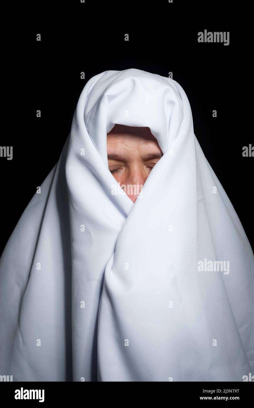 Man covered with white cloth against black background. Salvador, Bahia ...