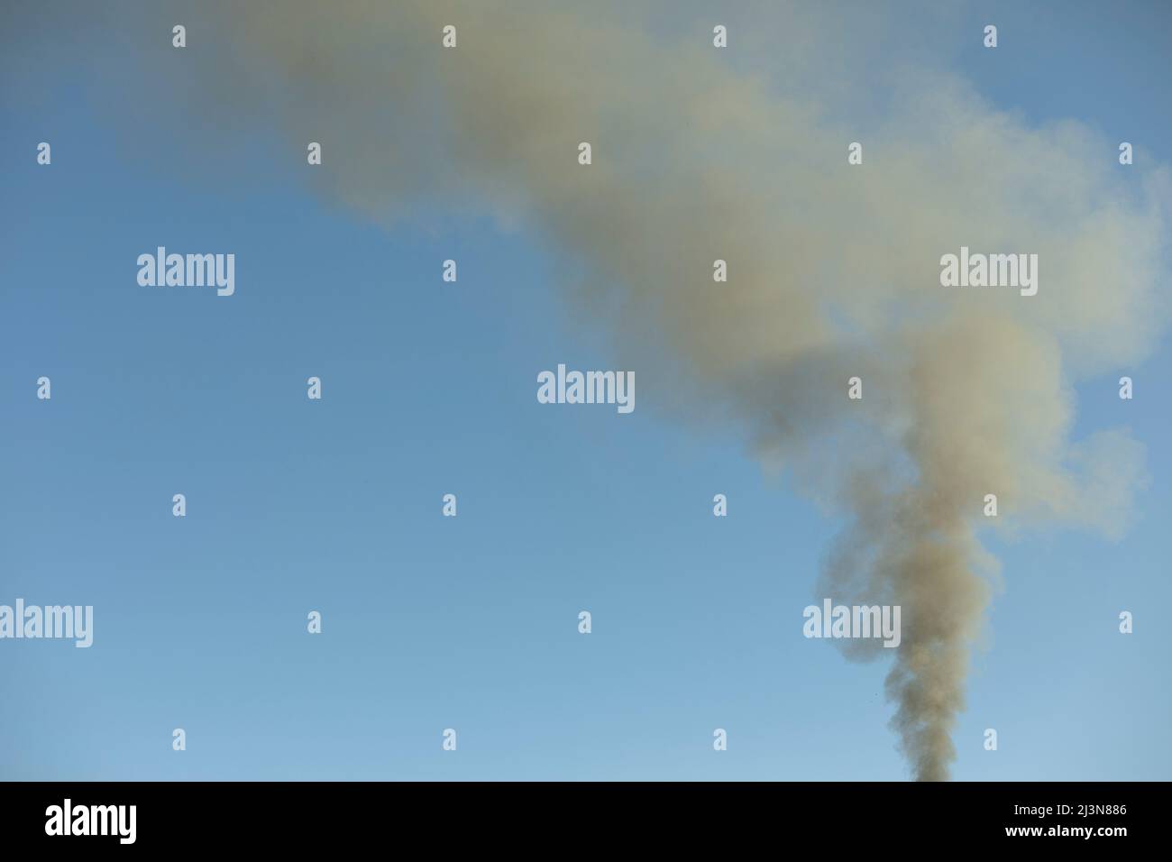 Smoke from chimney. Smoke in sky. Home heating. Pipe on roof of house ...