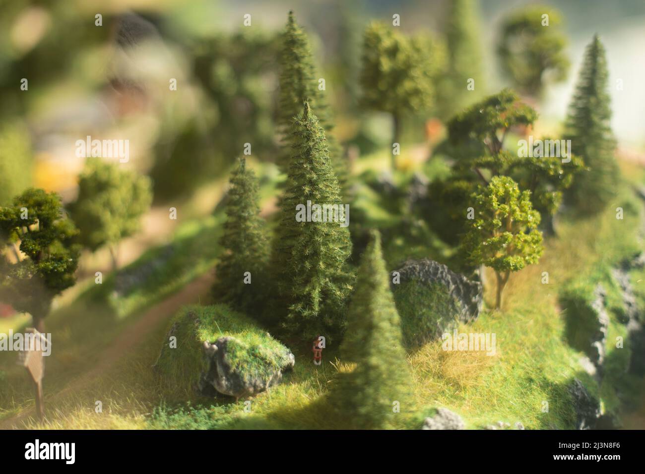 Model of mountainous area. Miniature trees in toy park. Mountain ...