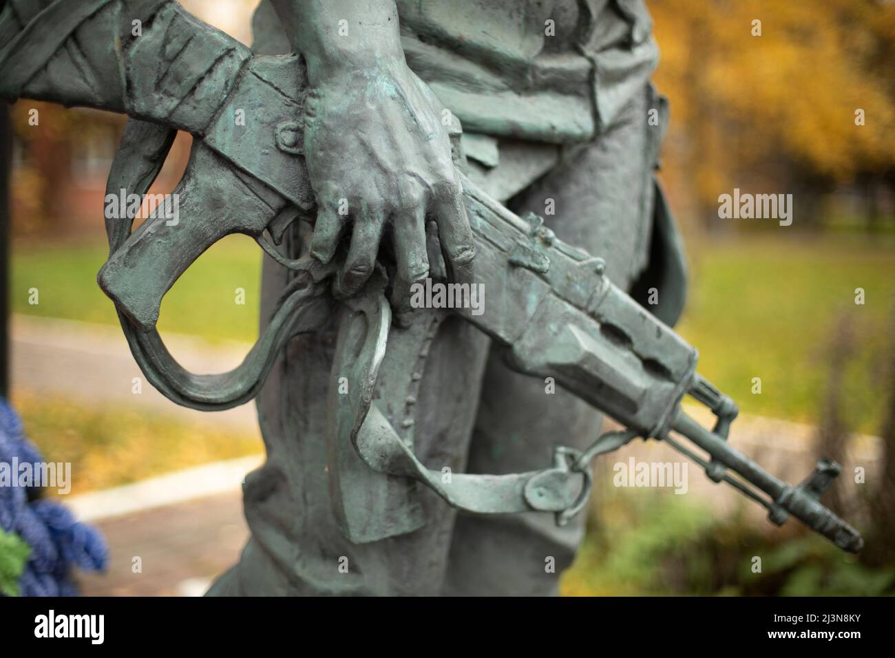 Sculpture of soldier. Machine gun in his hand. War Monument. Firearms ...