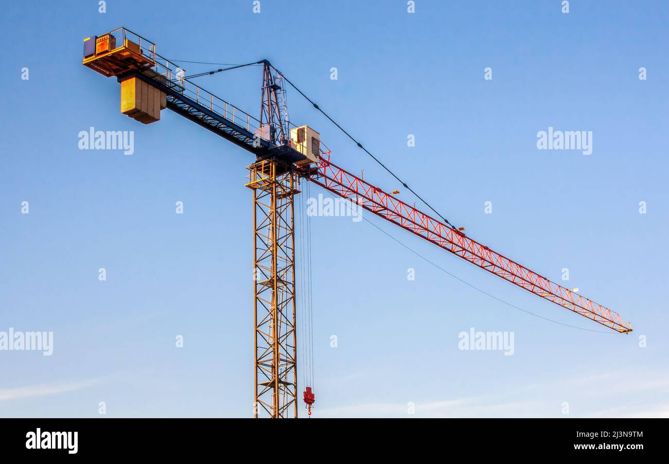 Construction crane. Diagonal view of the crane arm against the evening ...