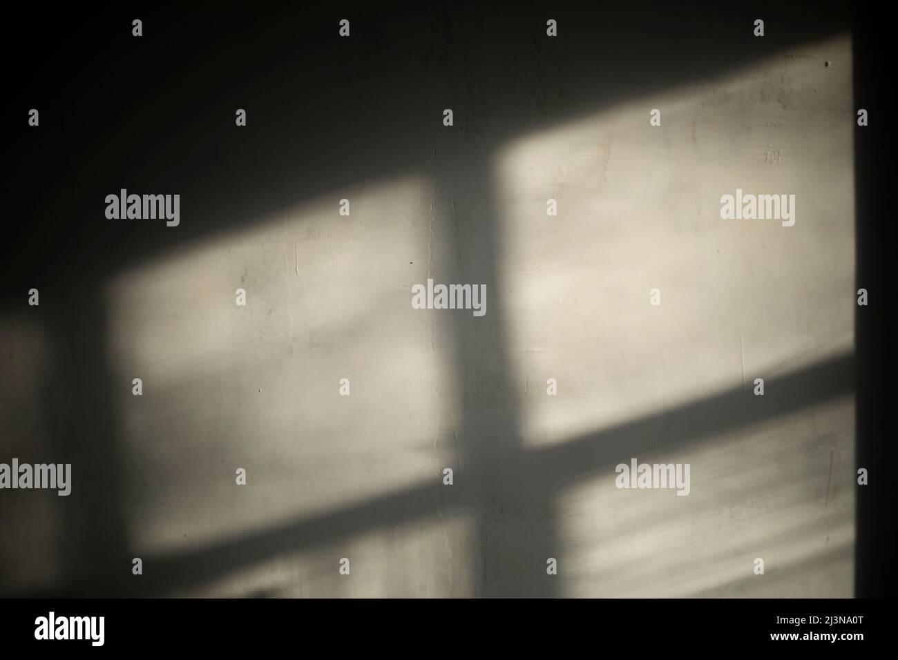 Shadow from window on white wall. Light in room. White wall in morning ...