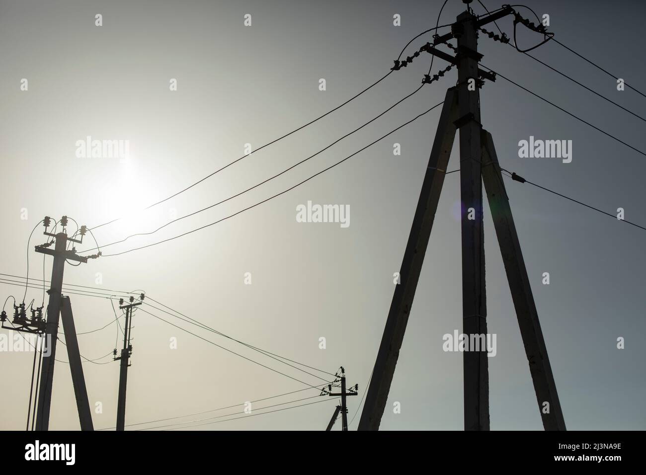 Poles with electrical wires. Silhouettes of communication racks. High ...