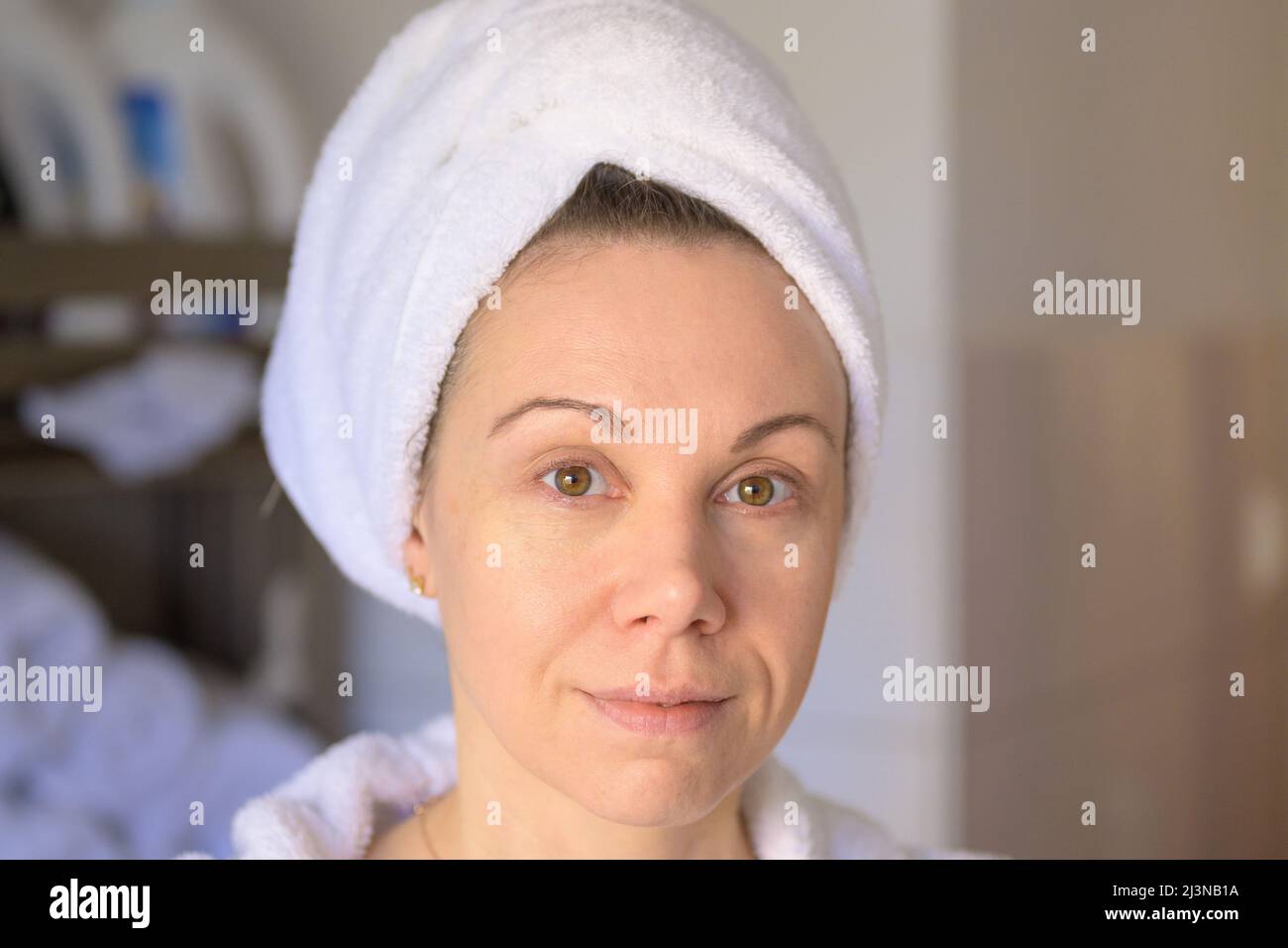 Portrait of senior woman with clean and clear face in bathrobe with ...