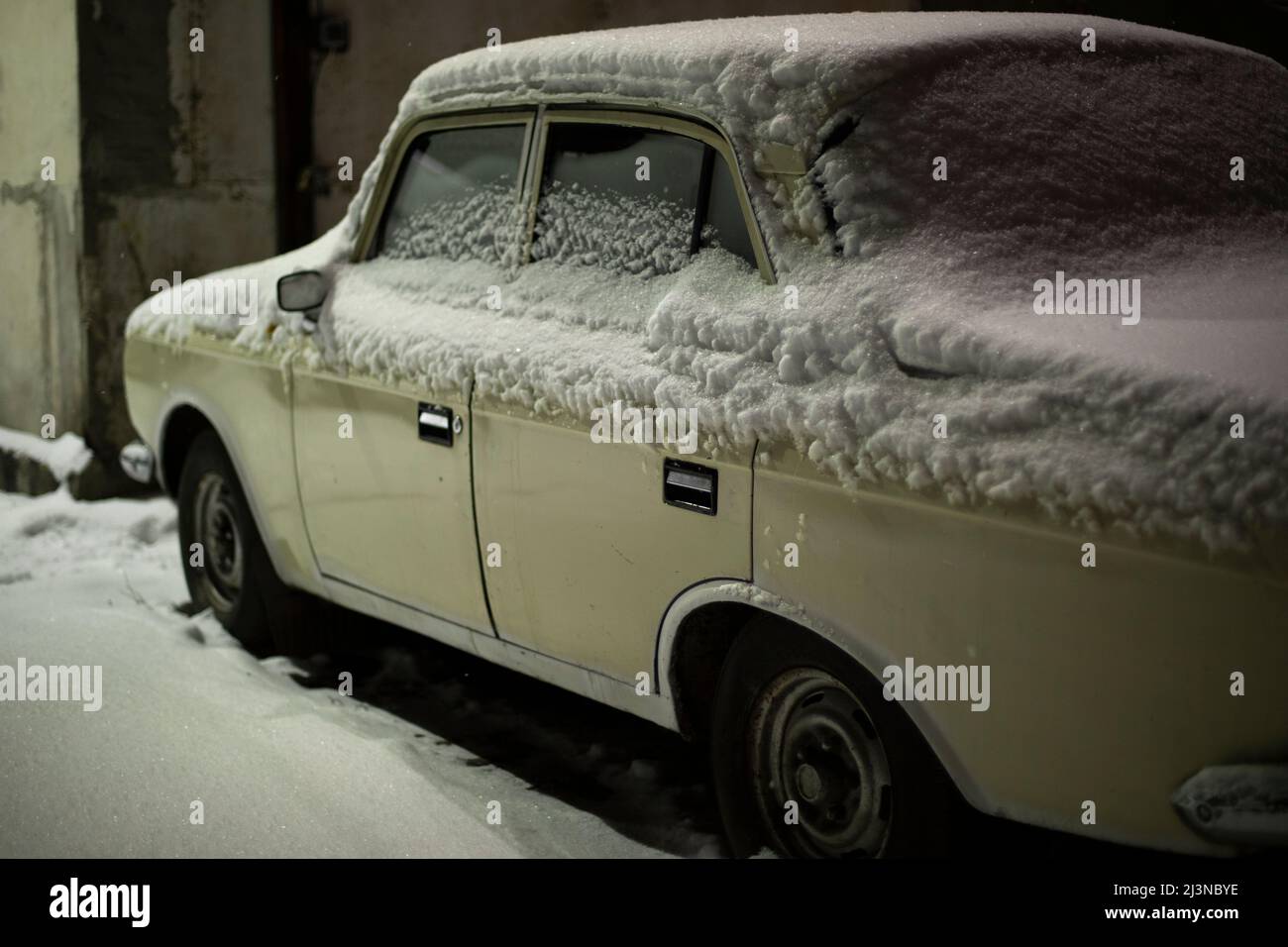 Car is in snow. Snow-covered vehicles in parking lot. Car is motionless ...