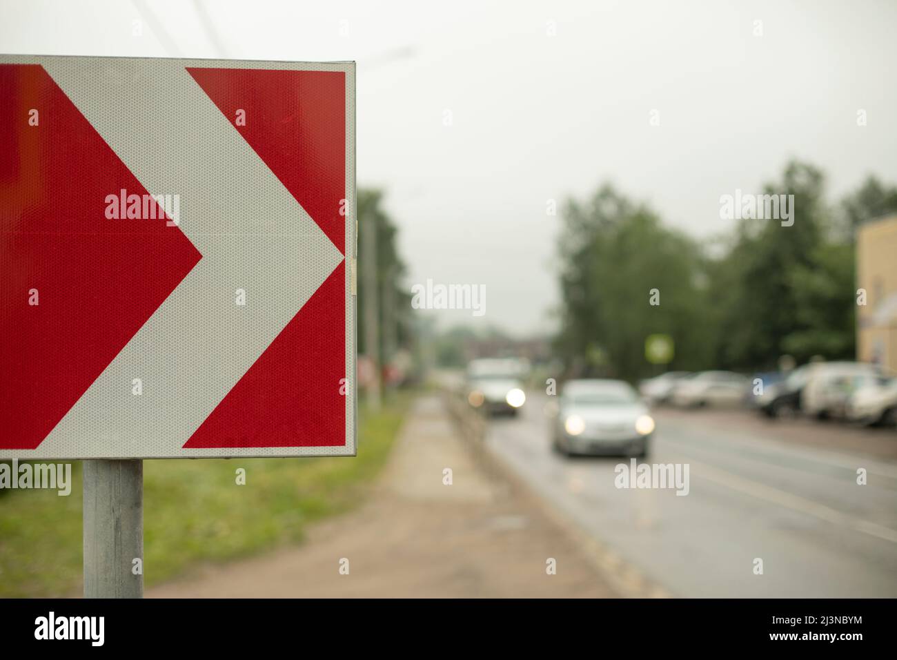 Sharp turn sign on road. Place of sharp bend in road. Red road sign ...