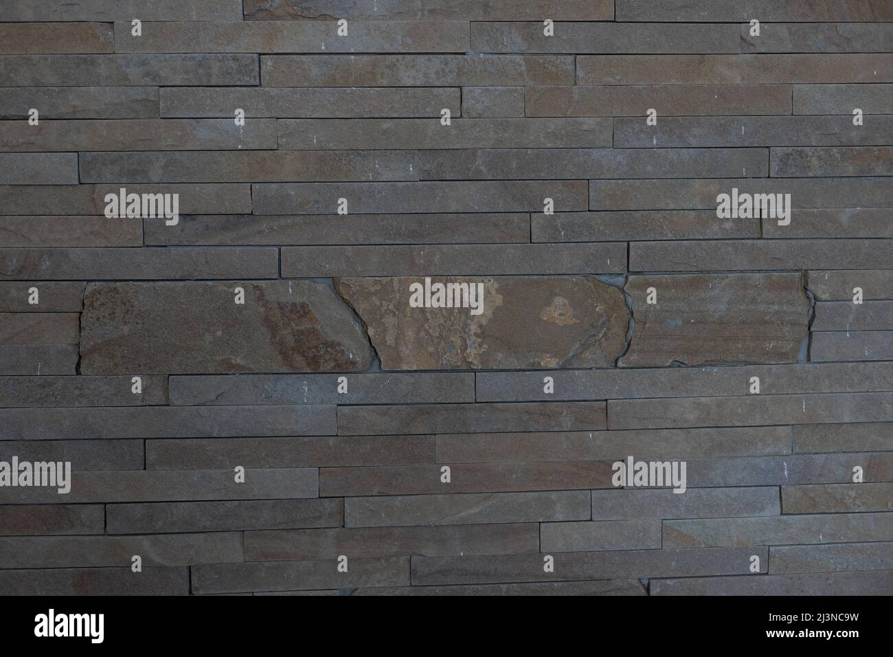 Elegant stone cladding wall made of gray granite with different shades ...