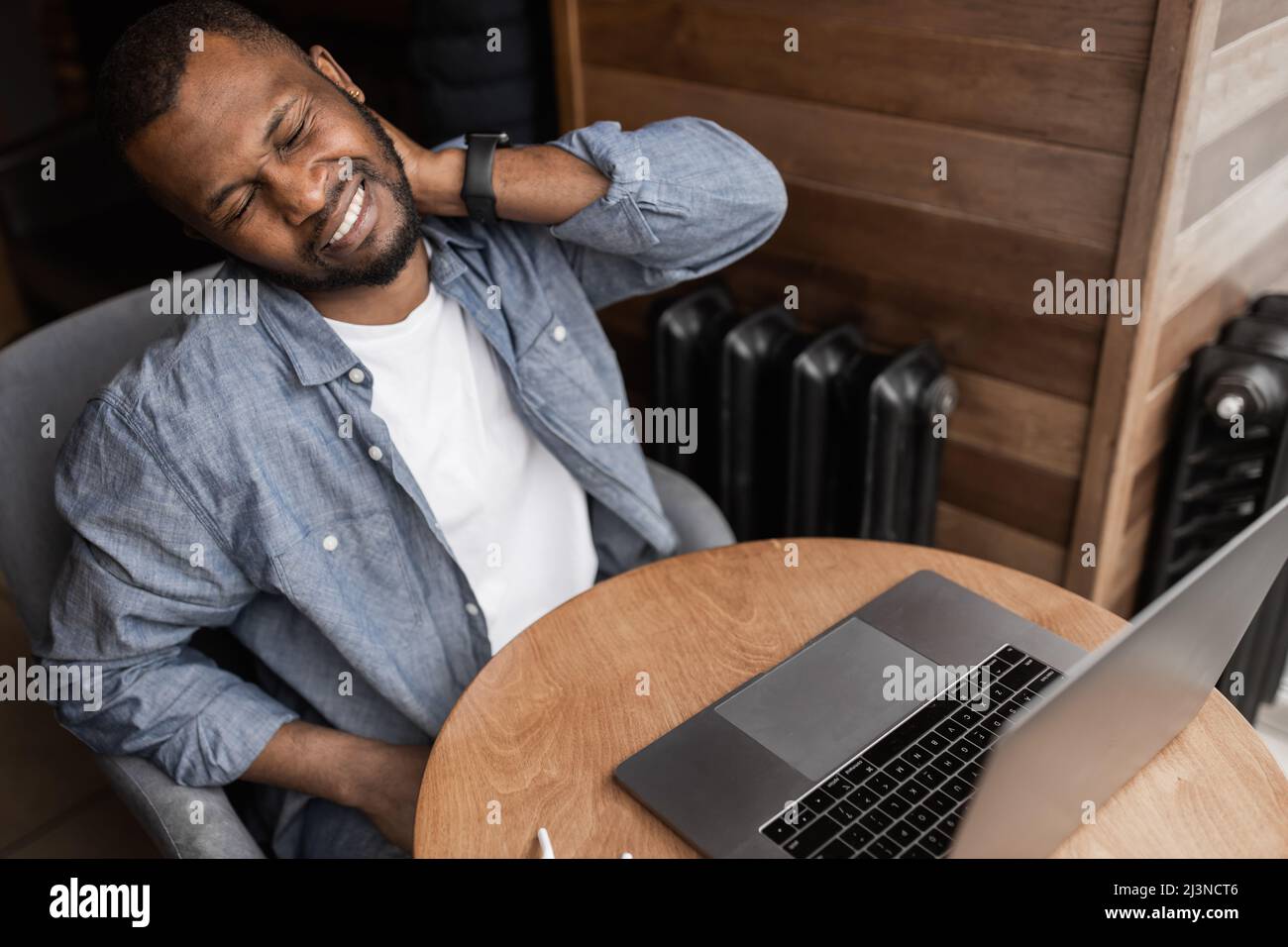 Portrait of a business young multiracial businessman massaging his neck ...