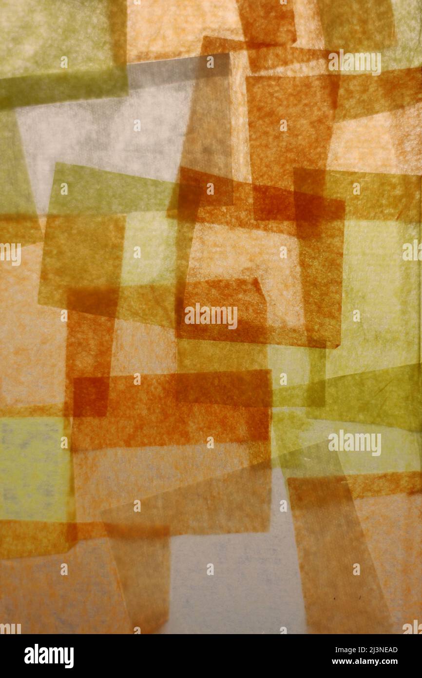 Craft tissue paper glued to a window as an abstract orange translucent ...