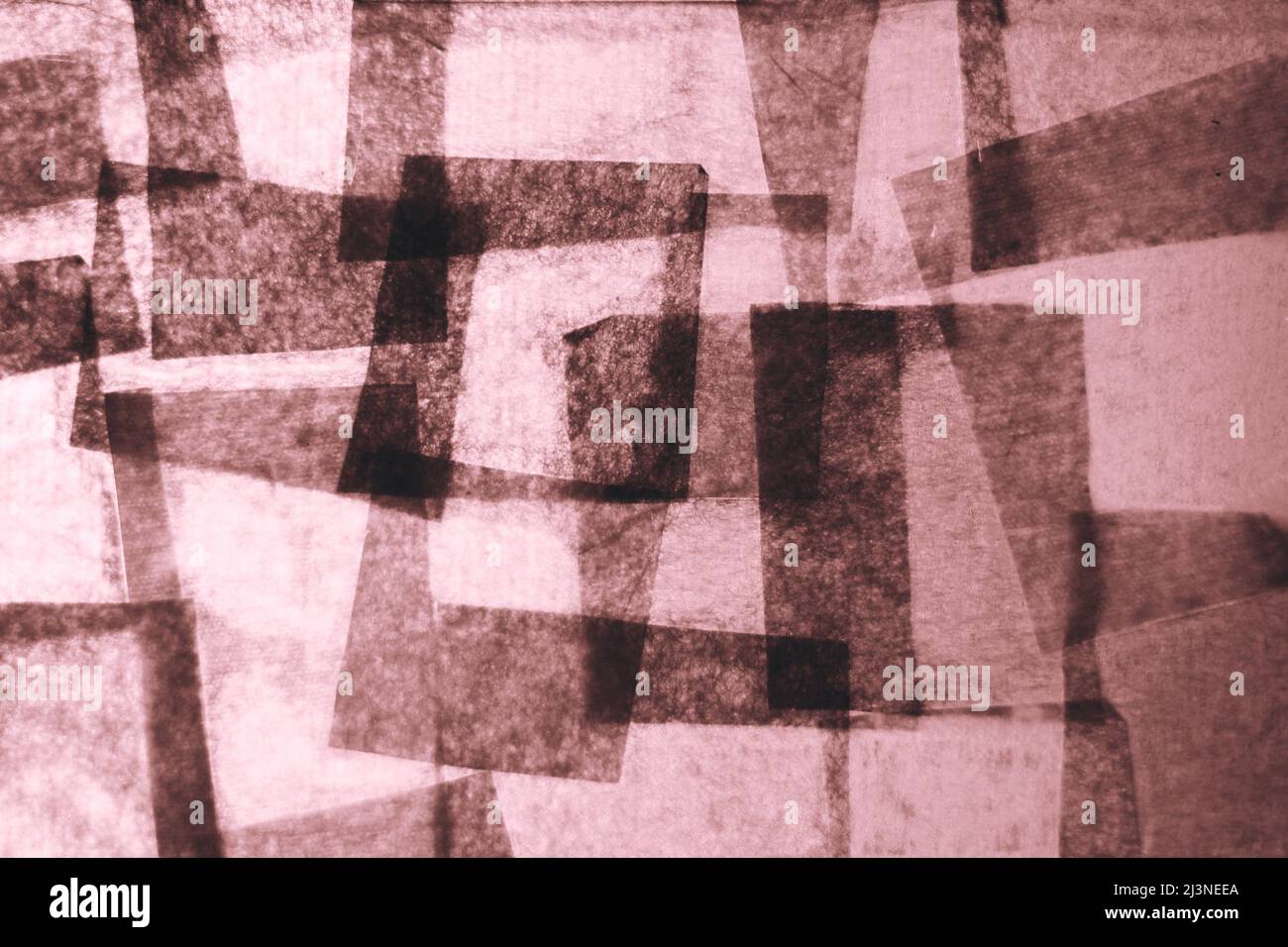 Craft tissue paper glued to a window as an abstract pink translucent ...