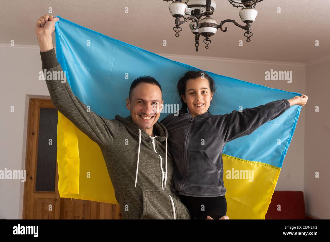 Ukrainian flag. Father with daughter at home Stock Photo - Alamy