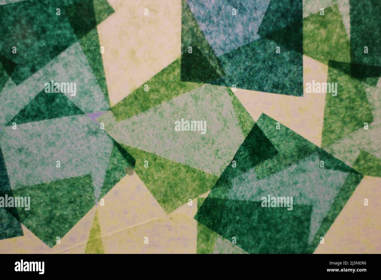 Craft tissue paper glued to a window as an abstract green translucent ...