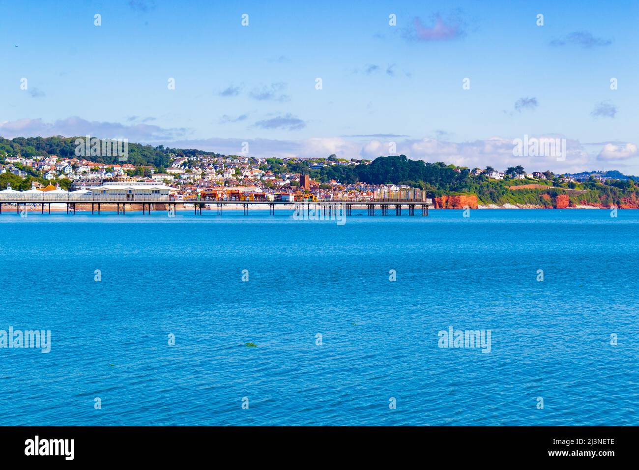 View of Paignton town seaside and beach with a long pier juts out from ...