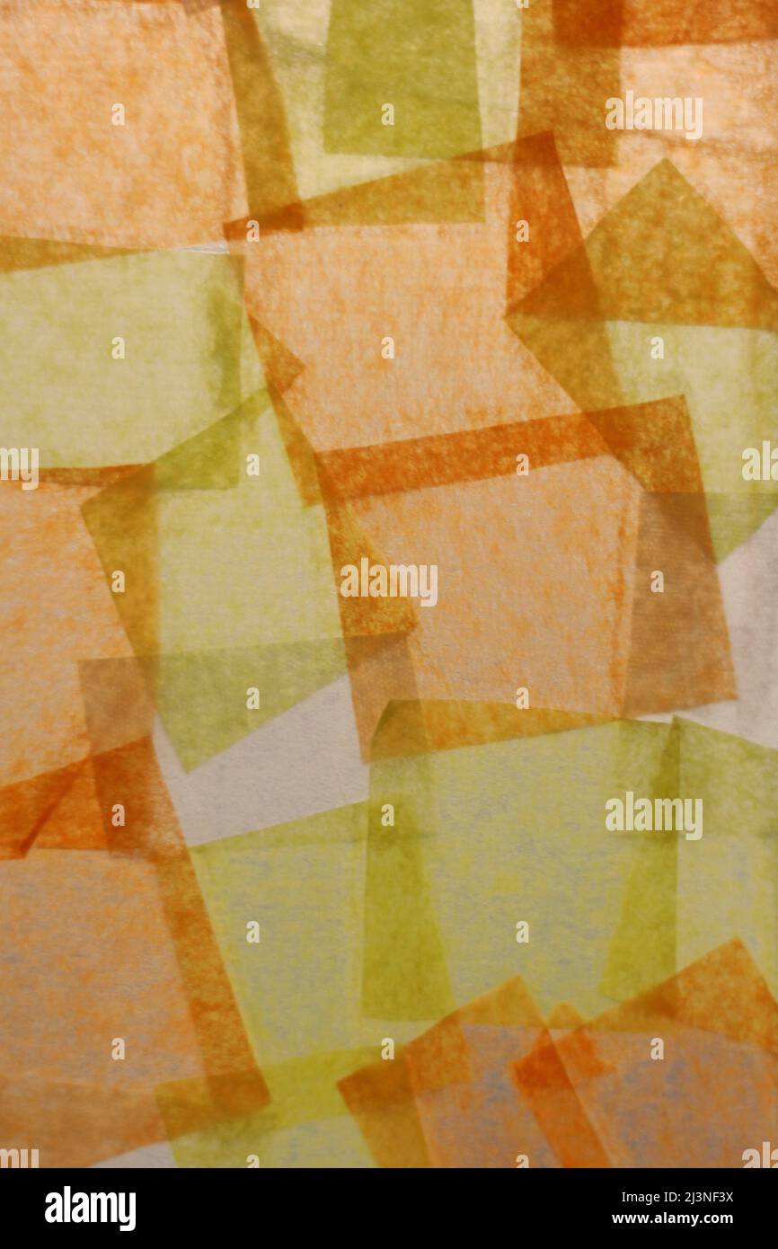 Craft tissue paper glued to a window as an abstract orange translucent ...