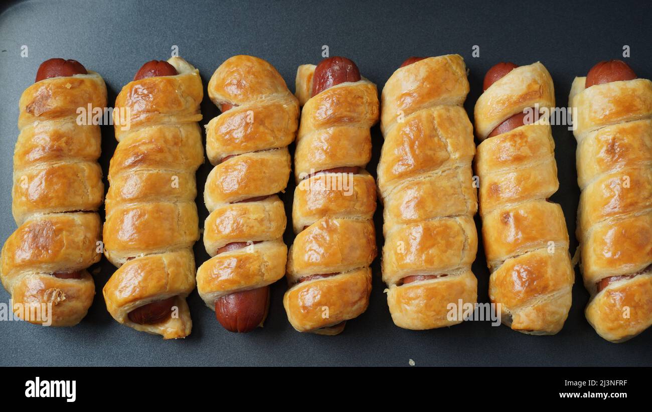 Sausage buns. Soft baked bun (dough )stuffed with sausage for fast food ...