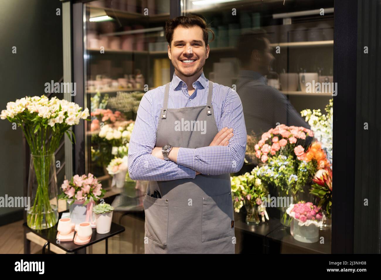 flower shop employee on the background of the refrigerator with fresh ...