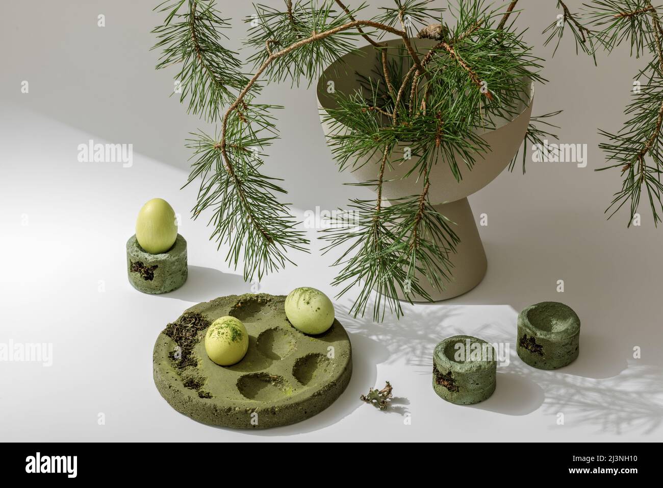Zero waste Easter concept. Easter eggs coloured with matcha tea in moss ...