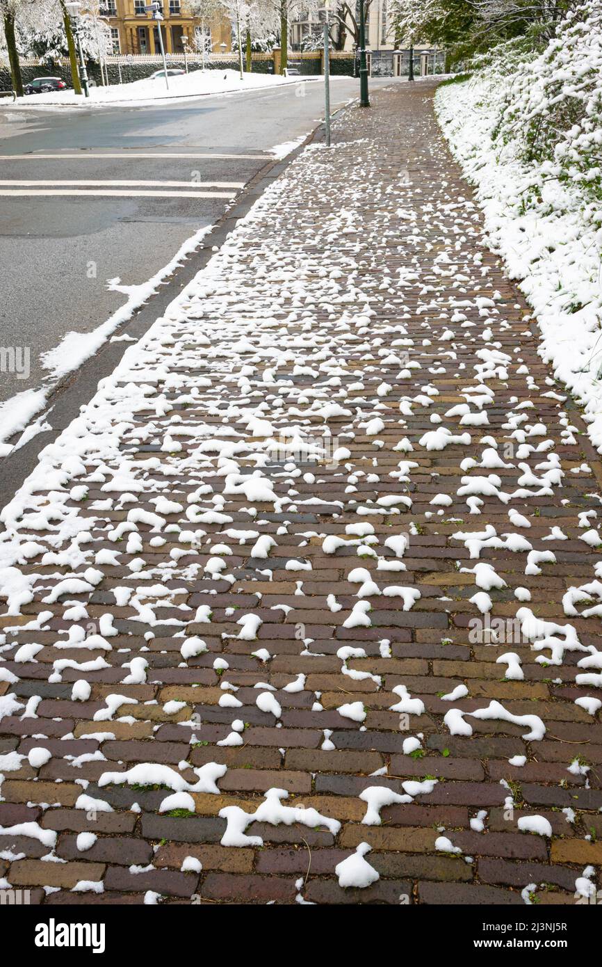 Pattern of snow on a sidewalk, fallen at a temperature around zero ...