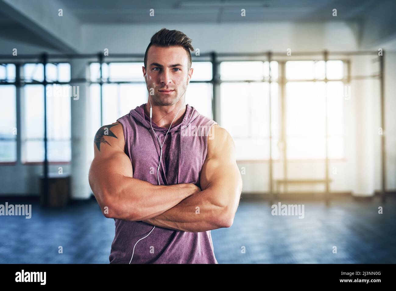 Ready to build some more muscle. Portrait of a muscular young man ...