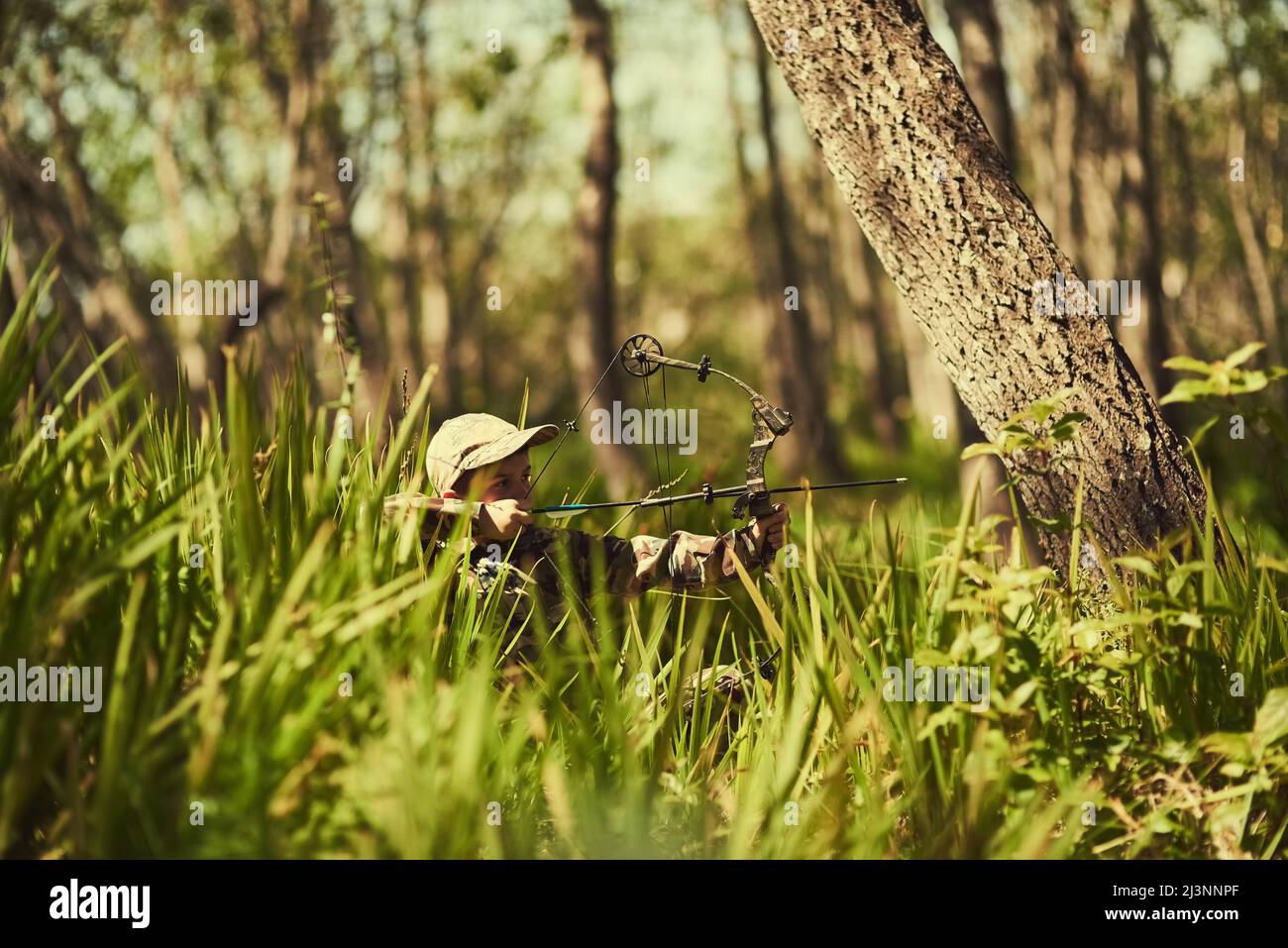 Boy playing with bow and arrow hi-res stock photography and images - Alamy