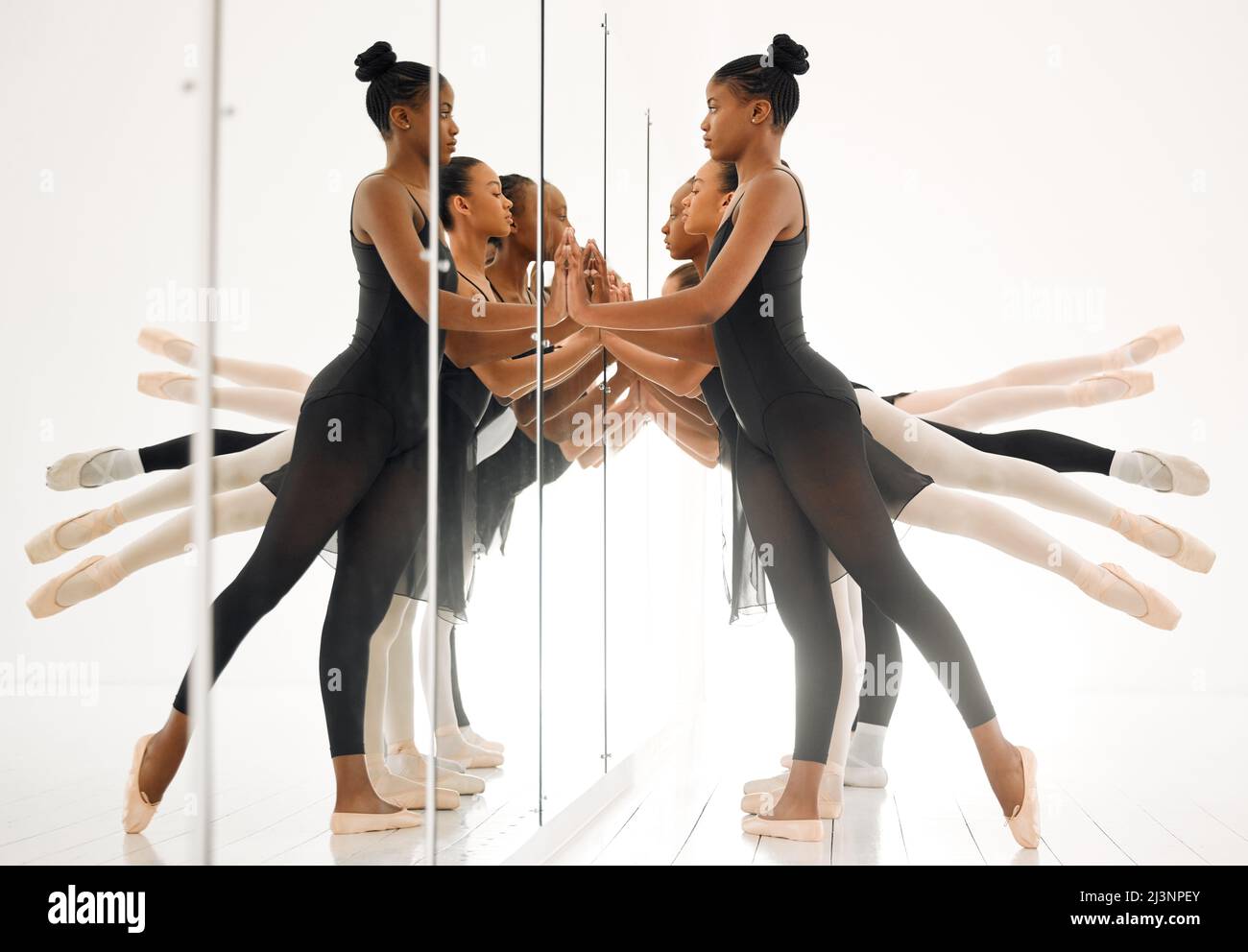 Just get up and dance. Shot of a group of ballet dancers practicing a ...