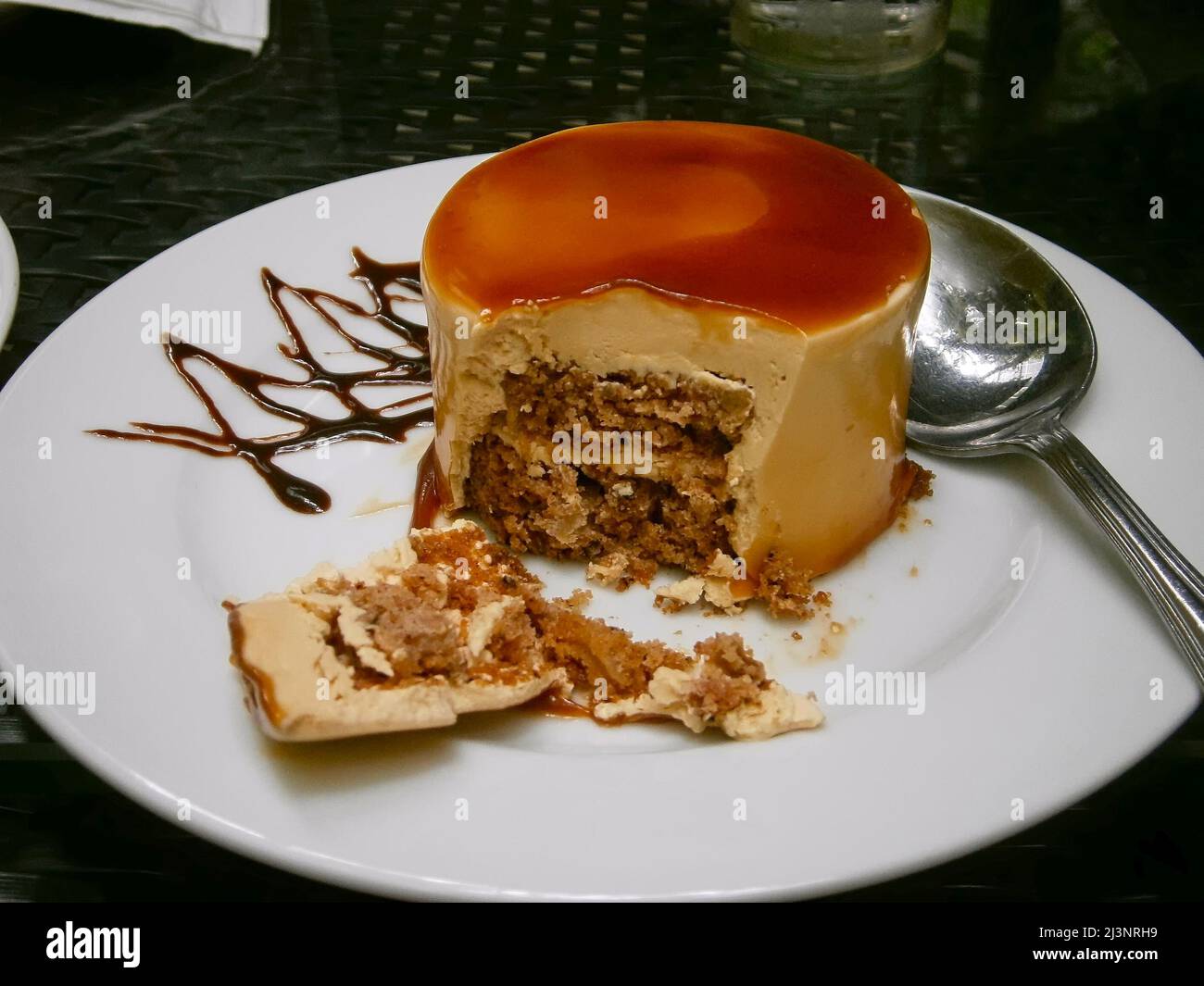 Slice of desert cake on a place with silver spoon at a restaurant Stock ...