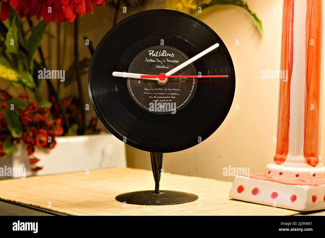 a recycled vinyl record clock on a stand in the home Stock Photo - Alamy
