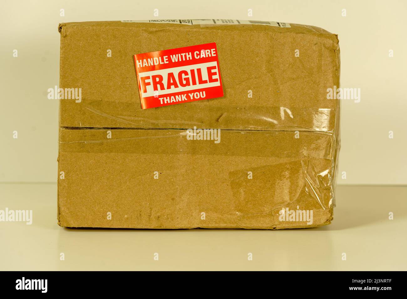 A close up of a package with a fragile, handle with care sticker label ...
