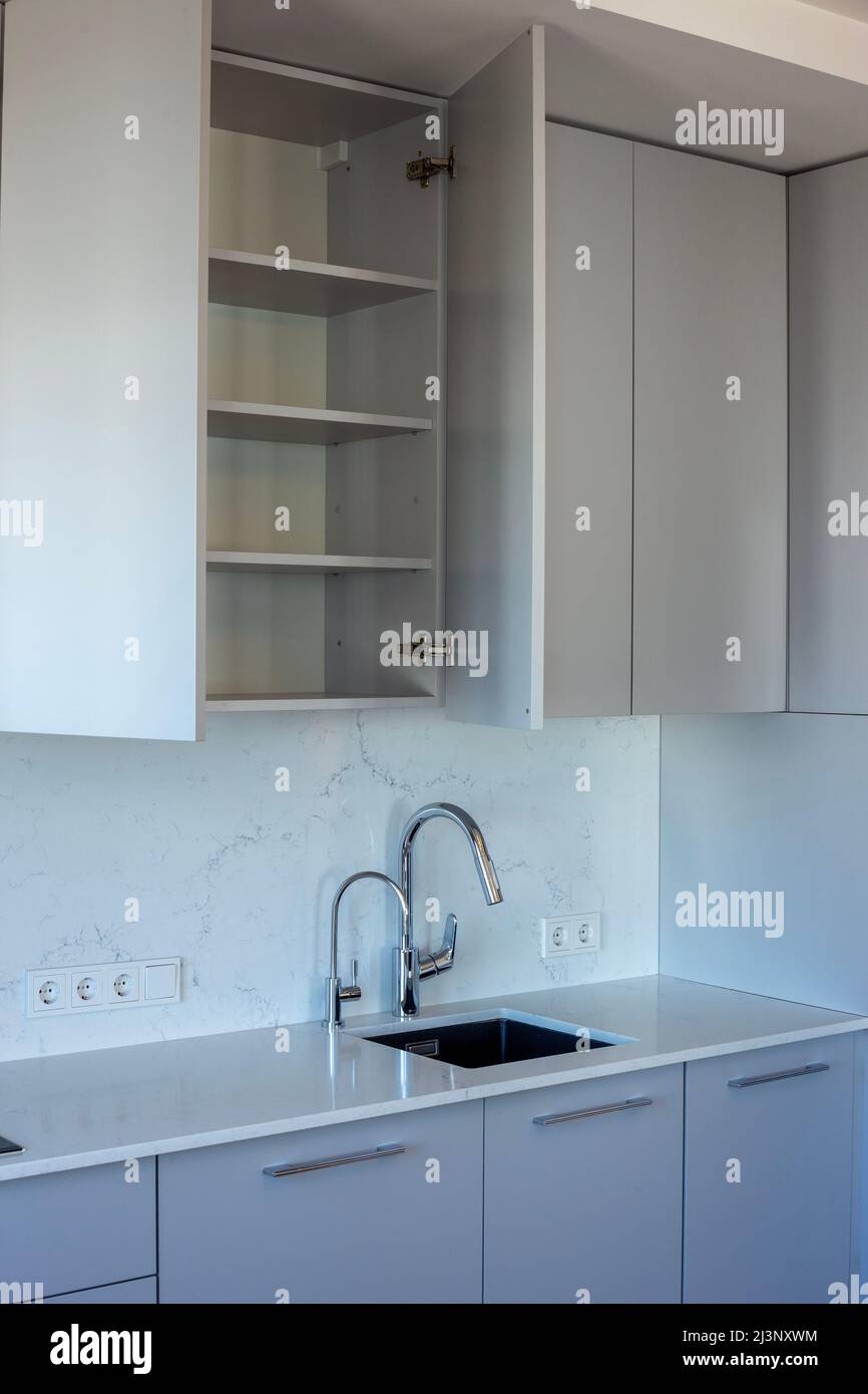 Kitchen with open cabinet and empty shelves Stock Photo - Alamy