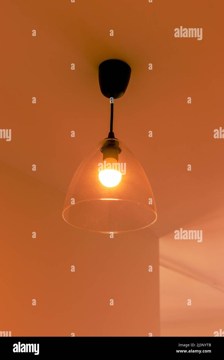 Lamp on the ceiling in the room in orange light Stock Photo - Alamy